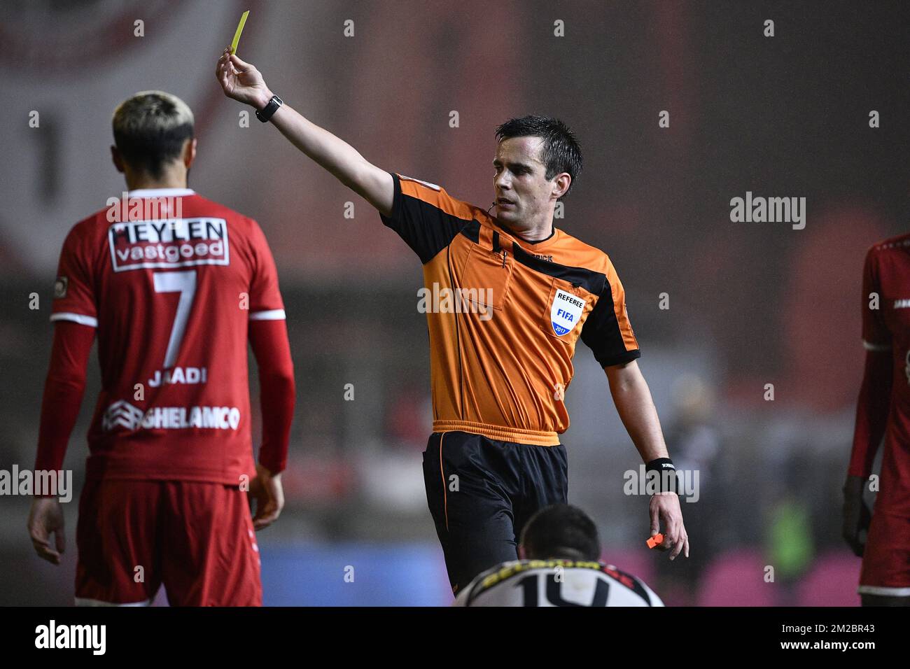Antwerp's Reda Jaadi receives a yellow card from referee Erik ...