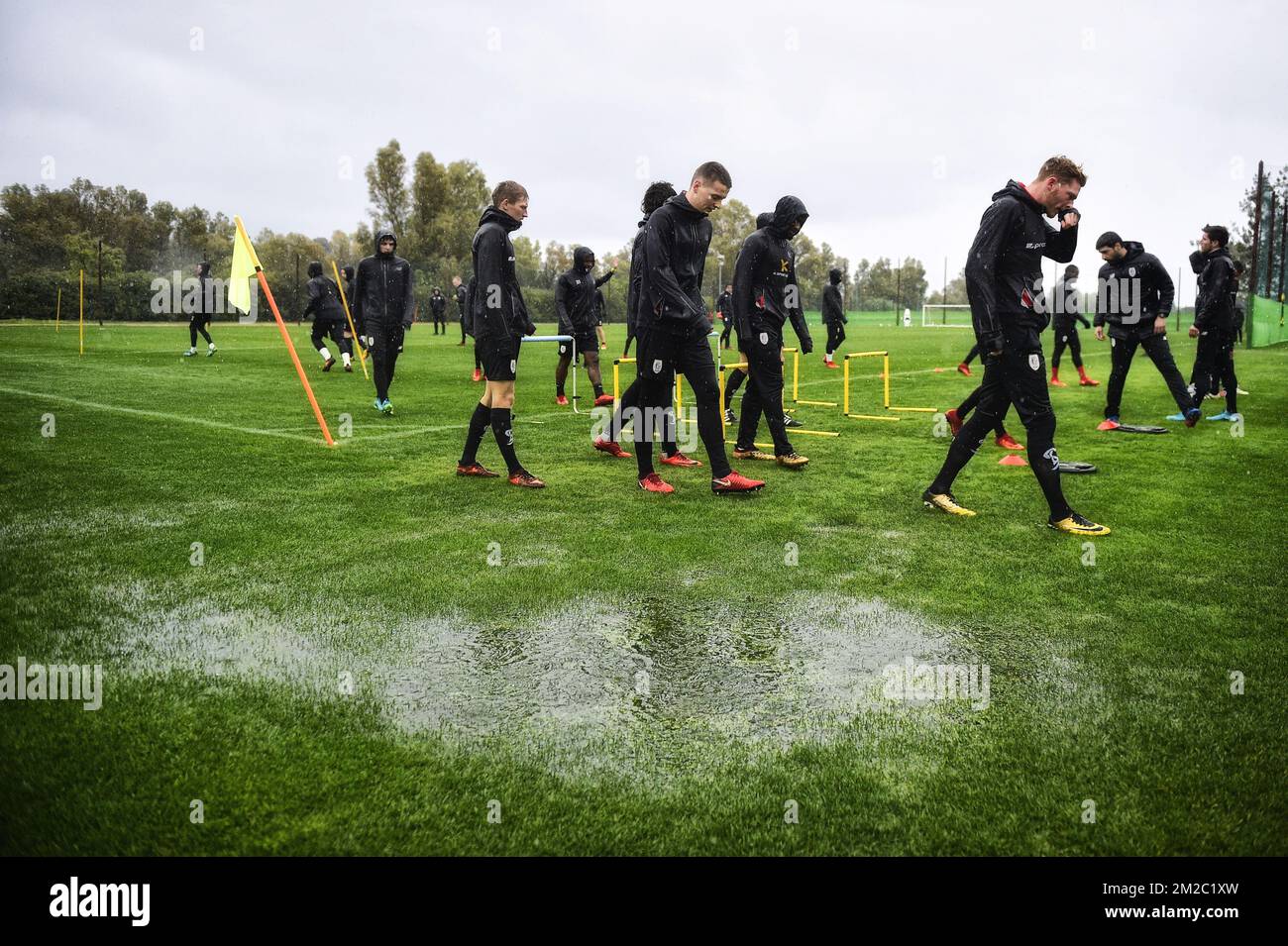 Standard's players pictured in action on a very wet pitch during day ...