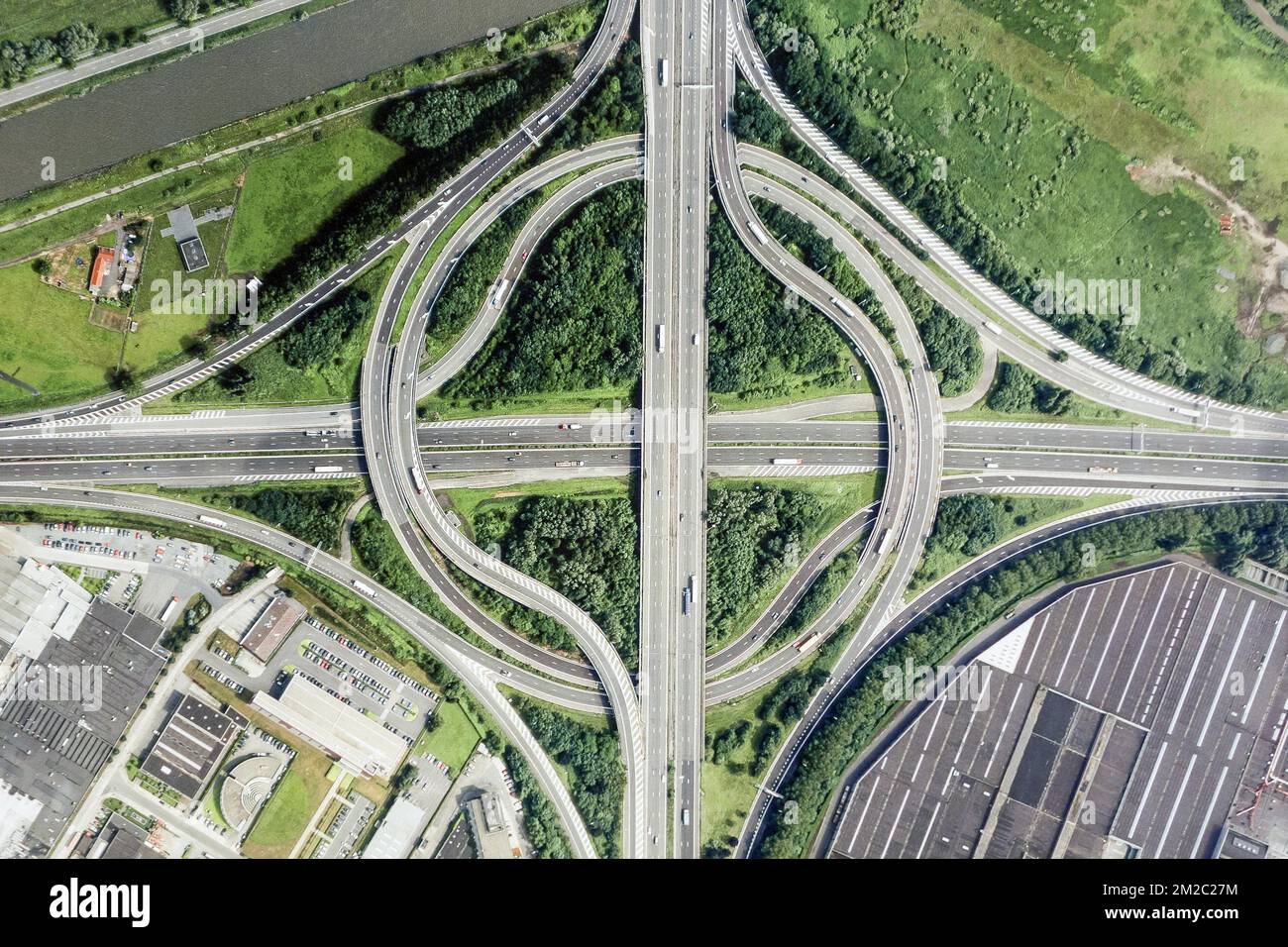 Aerial view over highway roundabout interchange / motorway interchange ...