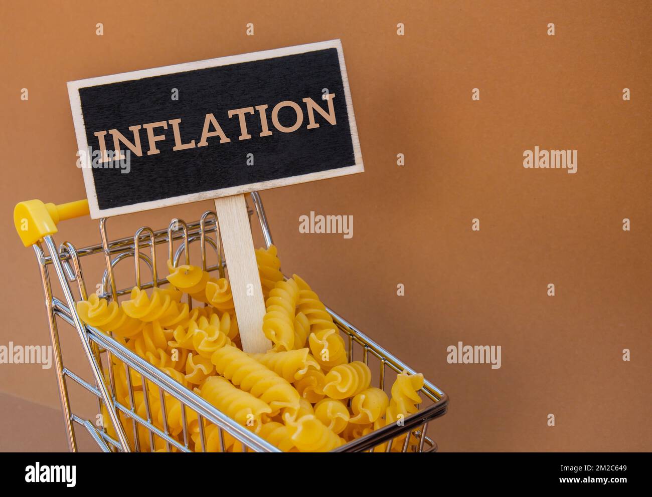 INFLATION text on Blackboard label against Shopping trolley cart Filled ...