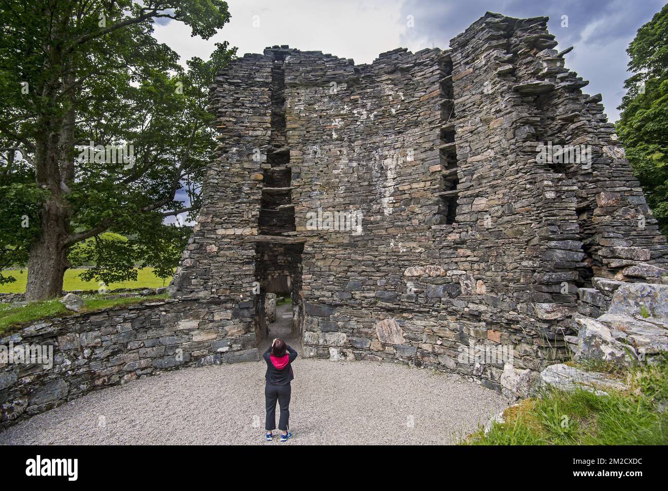 Tourist inside the Dun Telve broch near Glenelg, showing Iron Age ...