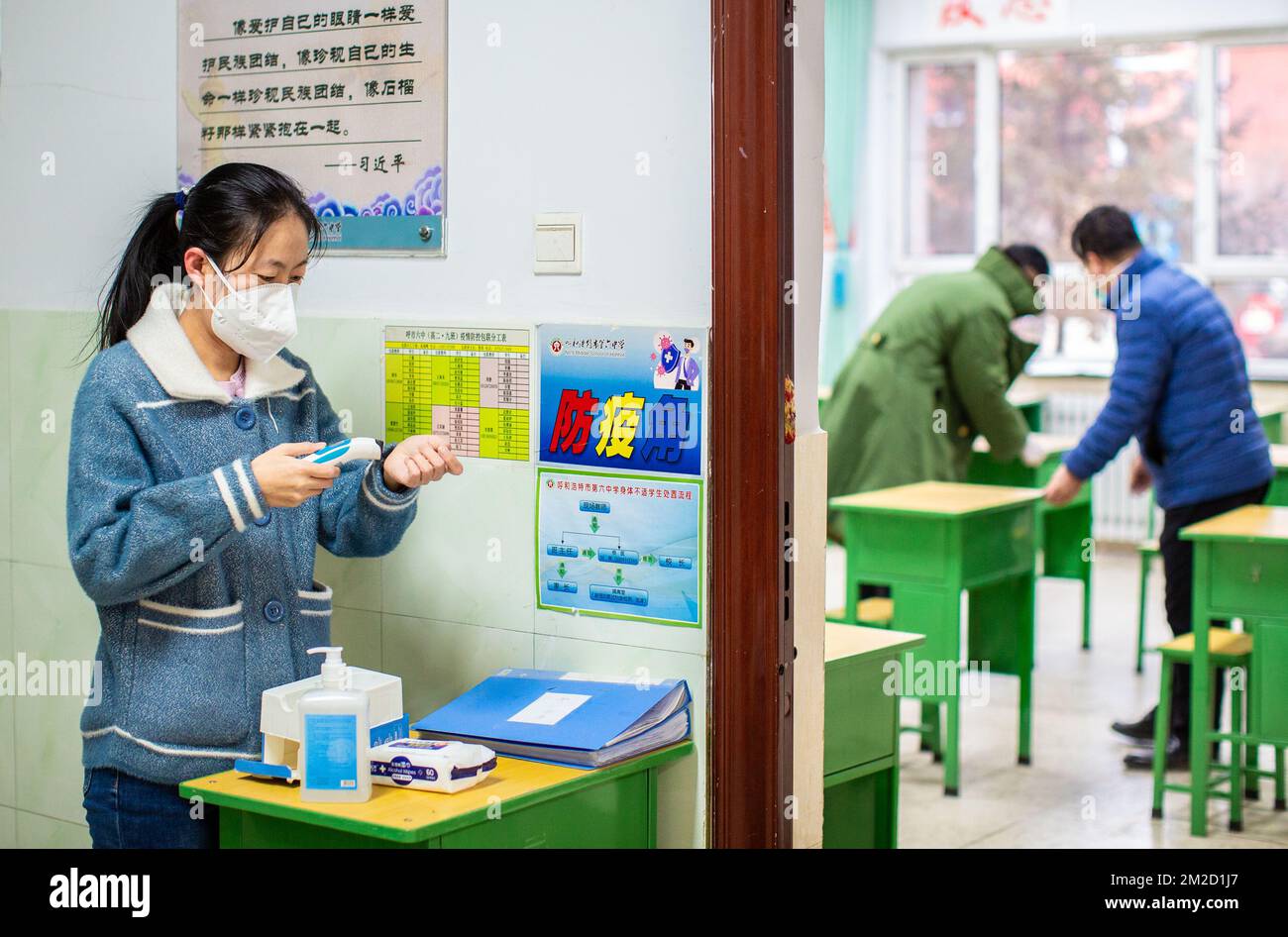 HOHHOT, CHINA - DECEMBER 14, 2022 - A teacher tests a temperature ...