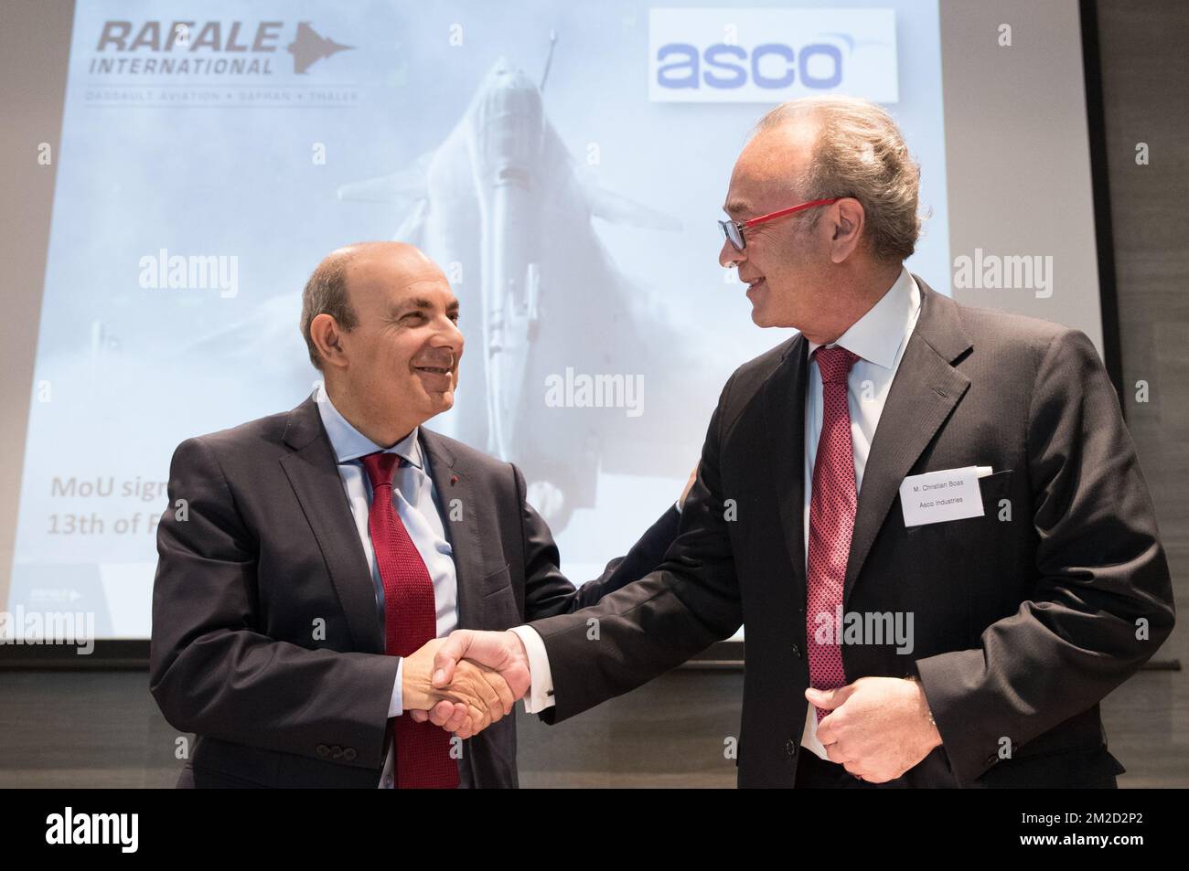 Dassault Aviation CEO Eric Trappier shakes hand with ASCO CEO Christian ...