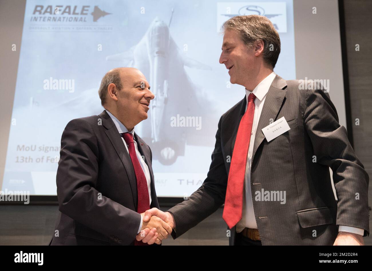 Dassault Aviation CEO Eric Trappier shakes hand with SABCA CEO Thibauld ...