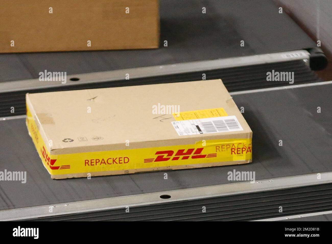 Illustration picture shows a DHL repacked package on a conveyor belt ...