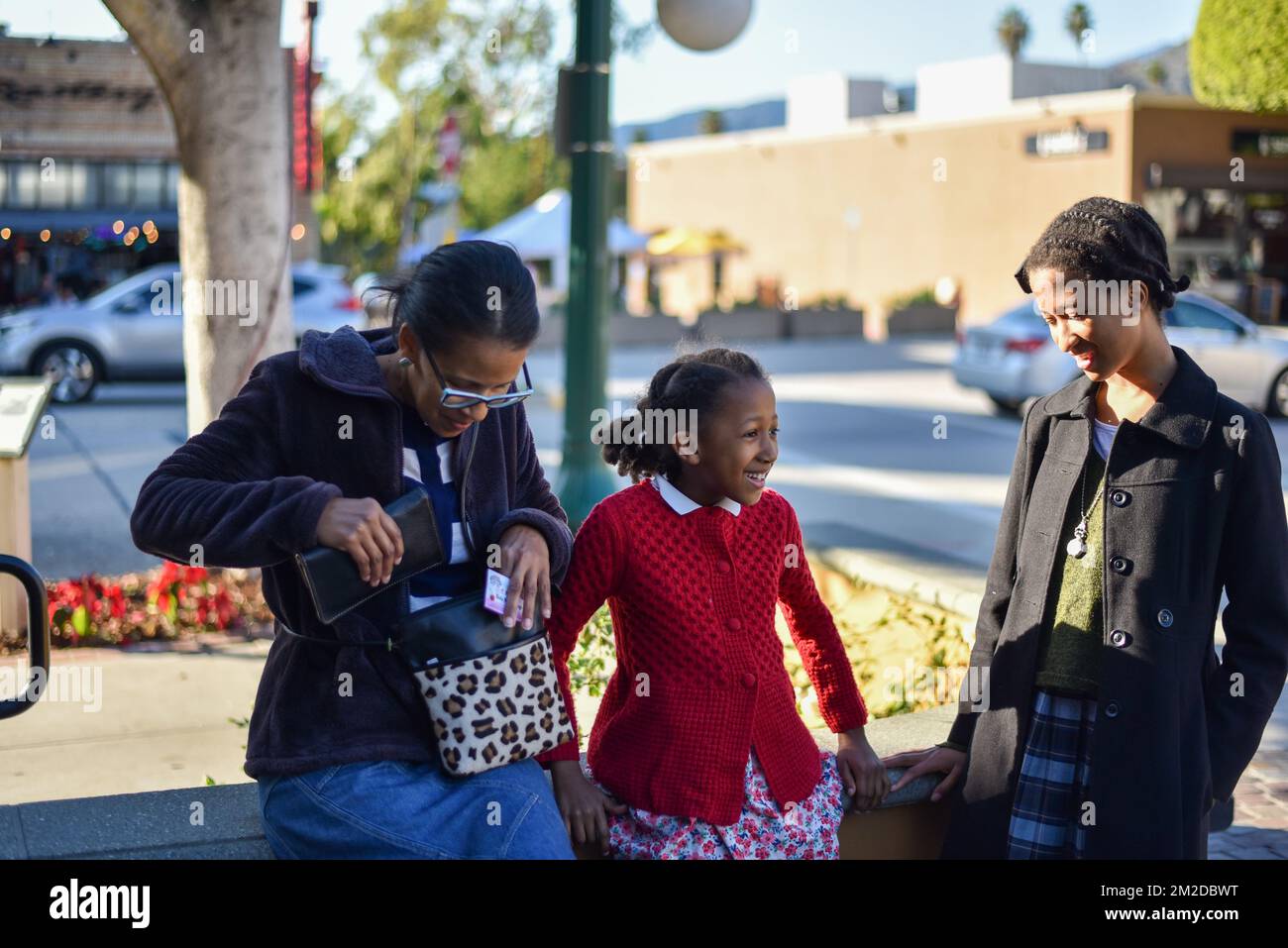 African American Mother and daughters dressed fashionably for winter ...