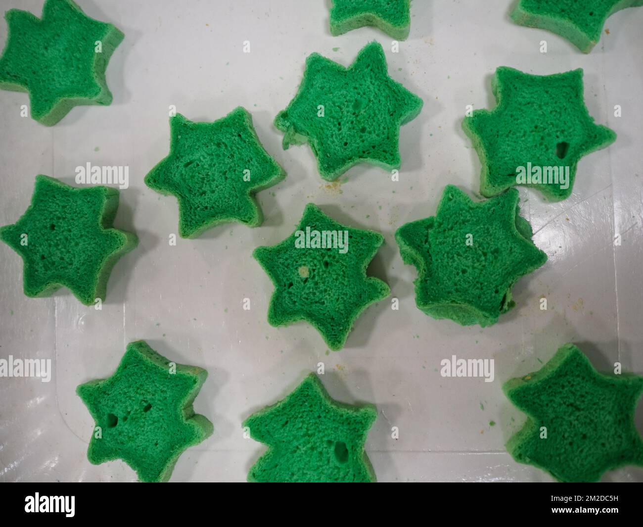 baker chef slicing red violet yellow and green star and heart shaped ...