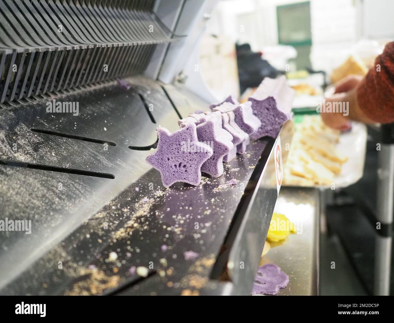 baker chef slicing red violet yellow and green star and heart shaped ...