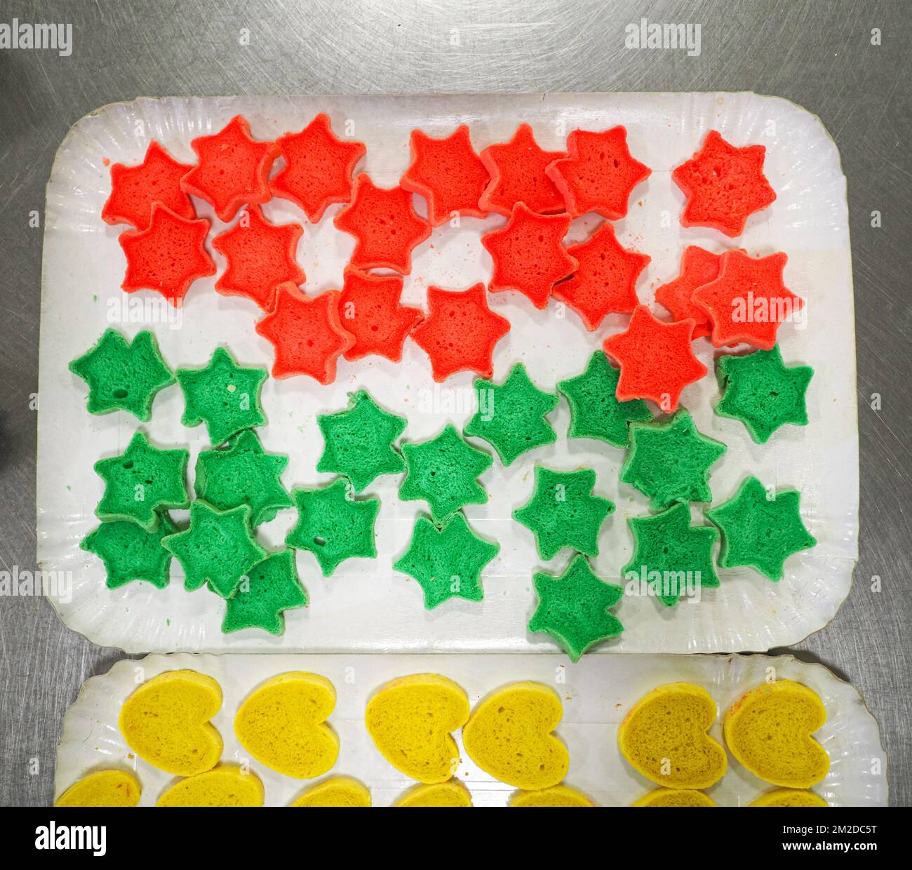 baker chef slicing red violet yellow and green star and heart shaped ...