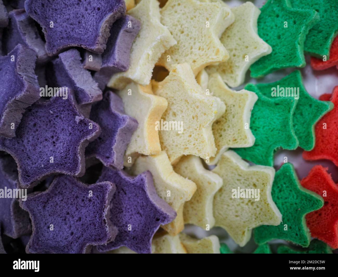 baker chef slicing red violet yellow and green star and heart shaped ...