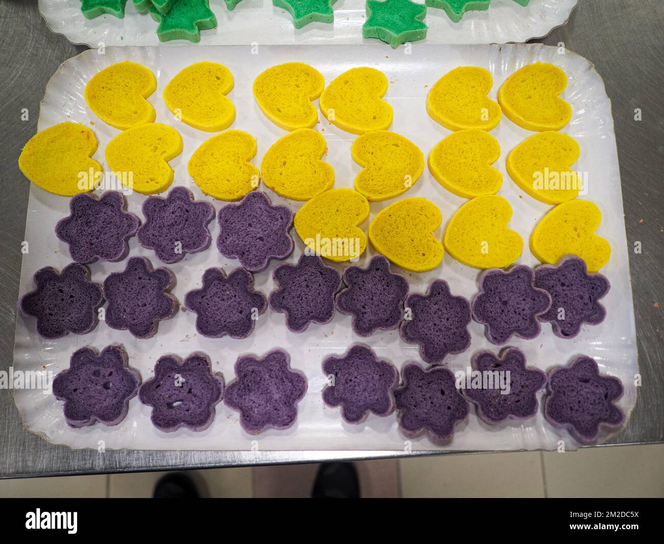 baker chef slicing red violet yellow and green star and heart shaped ...