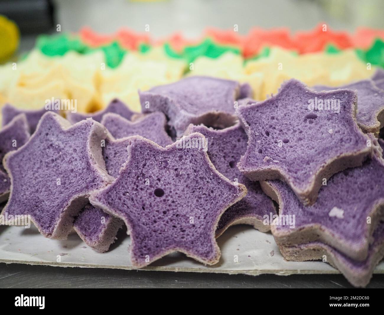 baker chef slicing red violet yellow and green star and heart shaped ...