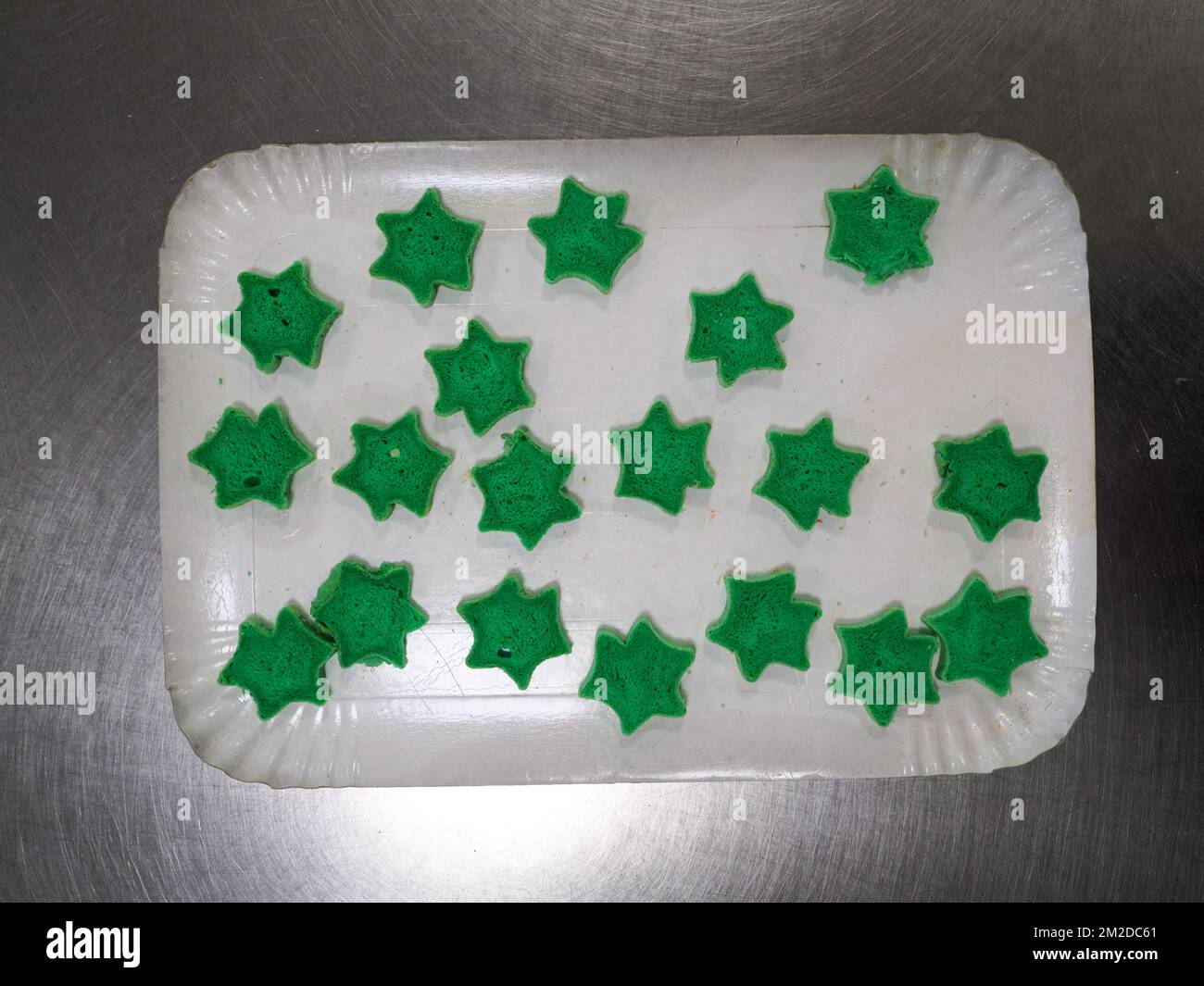 baker chef slicing red violet yellow and green star and heart shaped ...