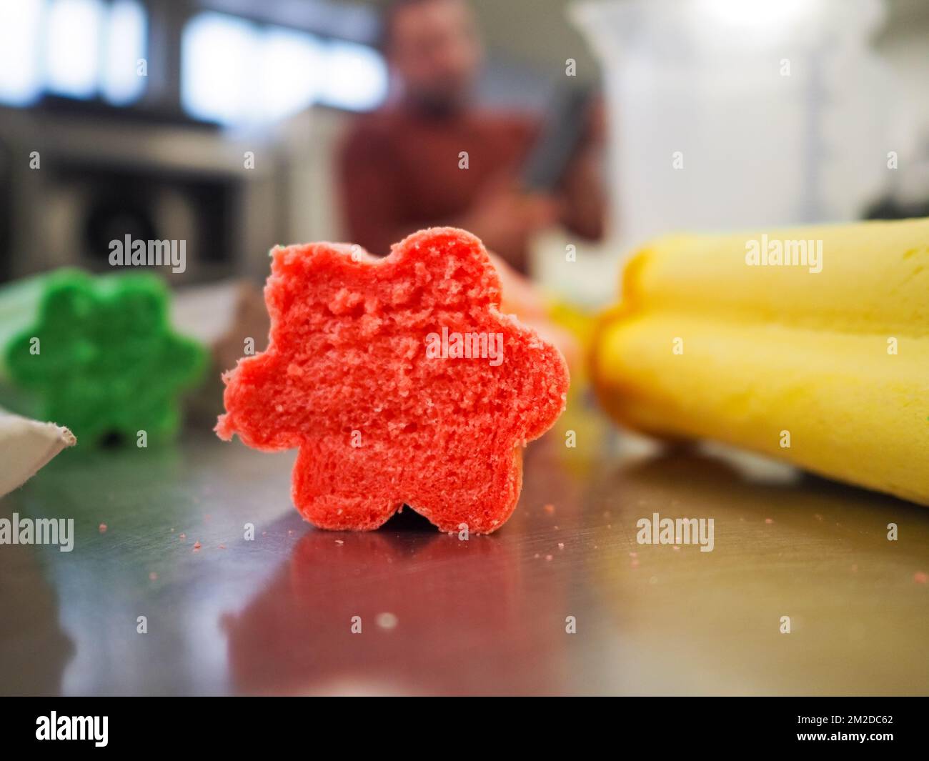 baker chef slicing red violet yellow and green star and heart shaped ...