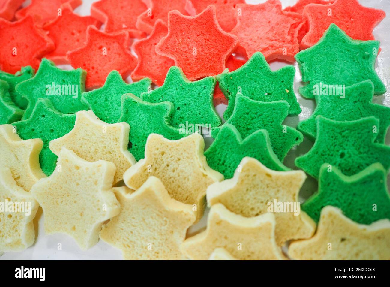 baker chef slicing red violet yellow and green star and heart shaped ...