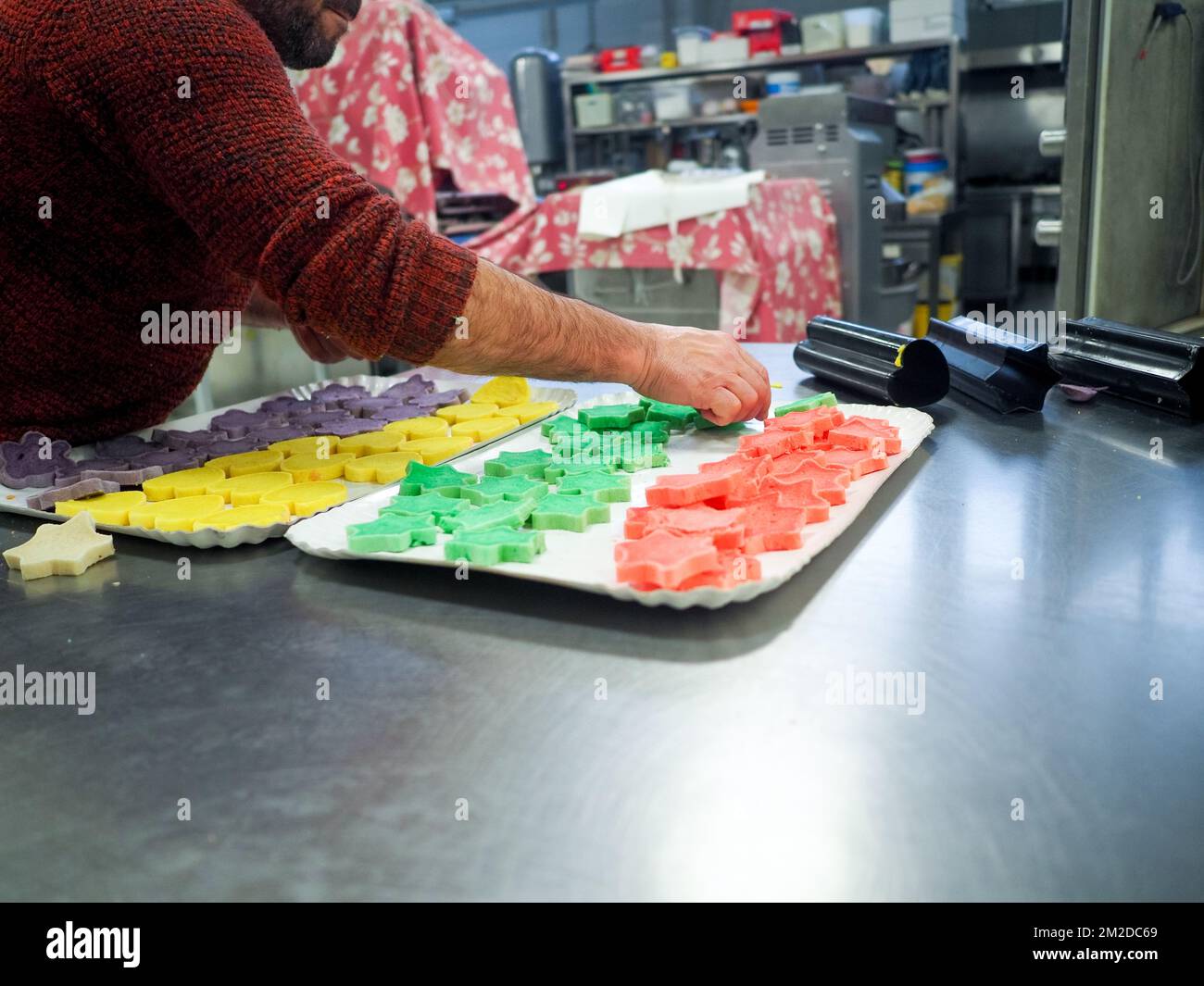 baker chef slicing red violet yellow and green star and heart shaped ...