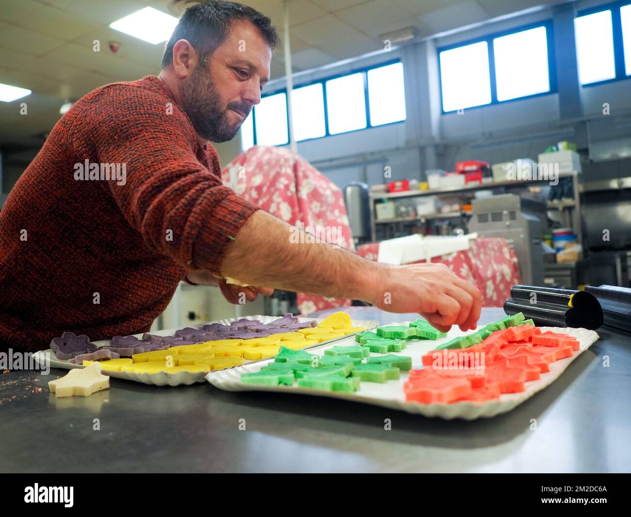 baker chef slicing red violet yellow and green star and heart shaped ...
