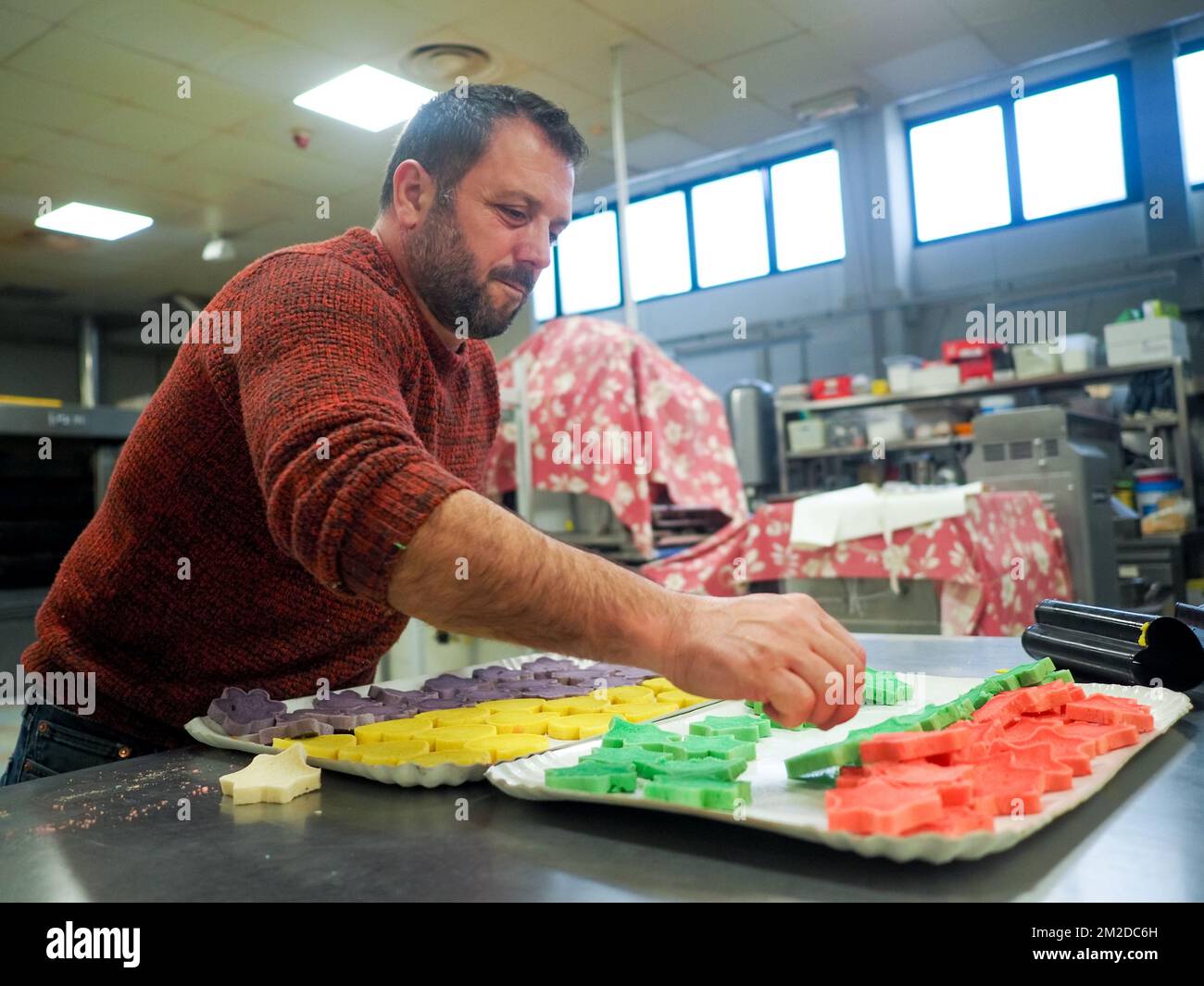 baker chef slicing red violet yellow and green star and heart shaped ...