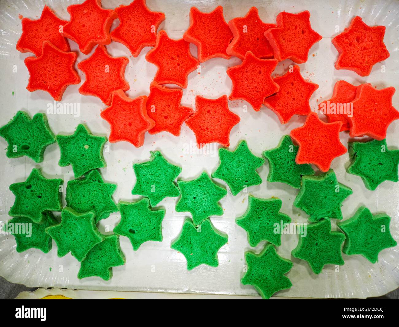 baker chef slicing red violet yellow and green star and heart shaped ...
