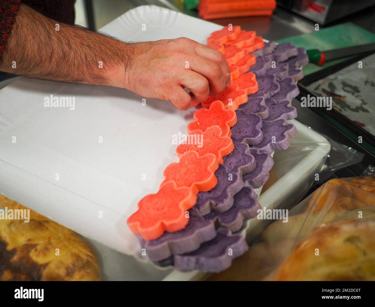 baker chef slicing red violet yellow and green star and heart shaped ...