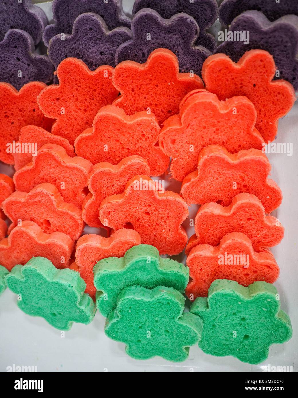 baker chef slicing red violet yellow and green star and heart shaped ...