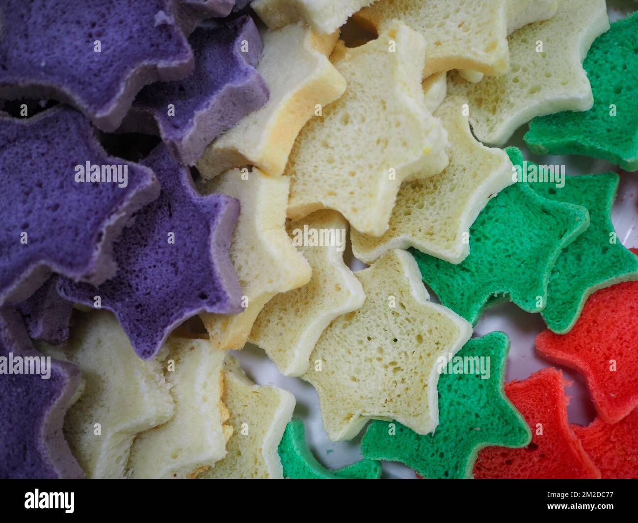 baker chef slicing red violet yellow and green star and heart shaped ...
