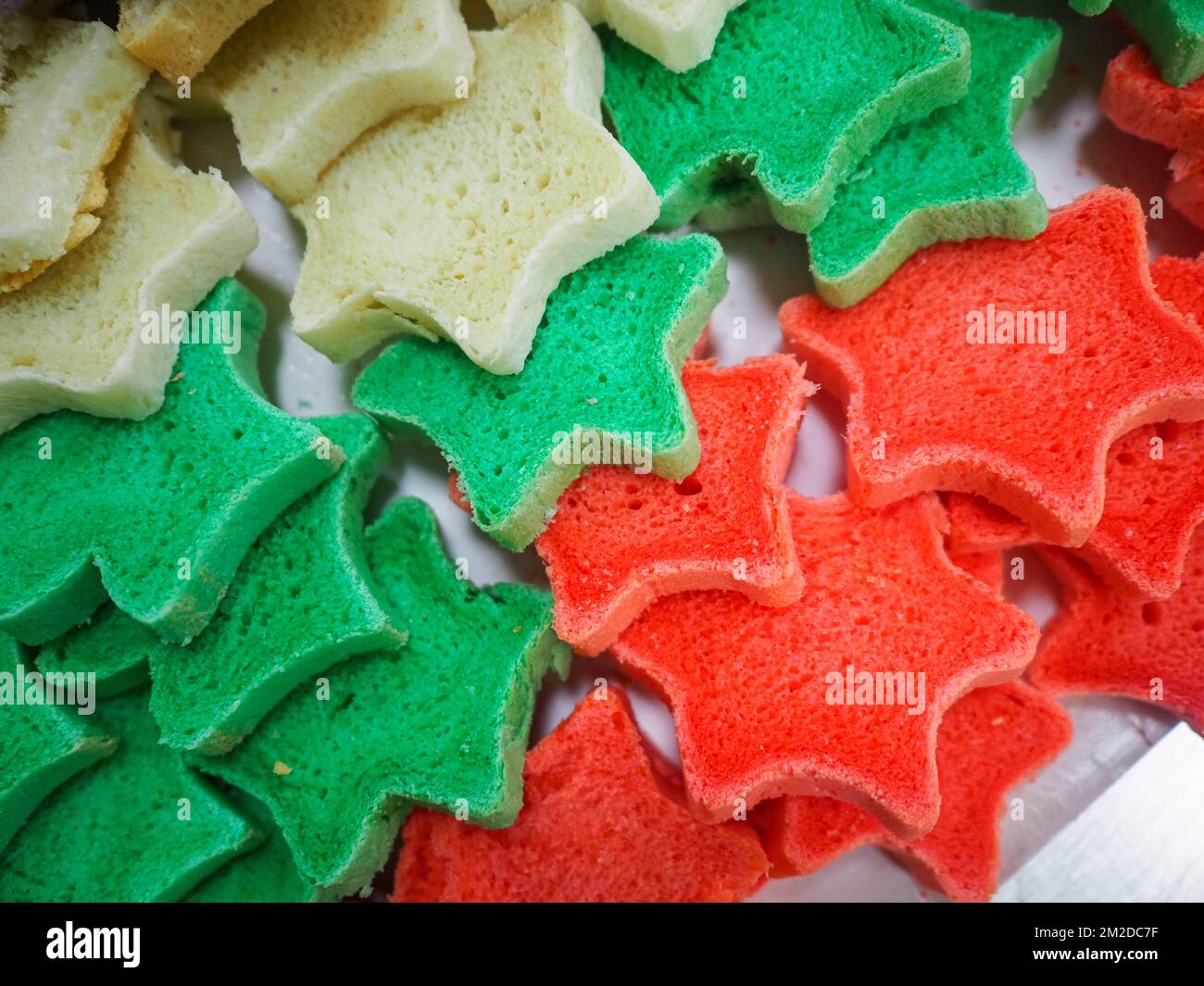 baker chef slicing red violet yellow and green star and heart shaped ...
