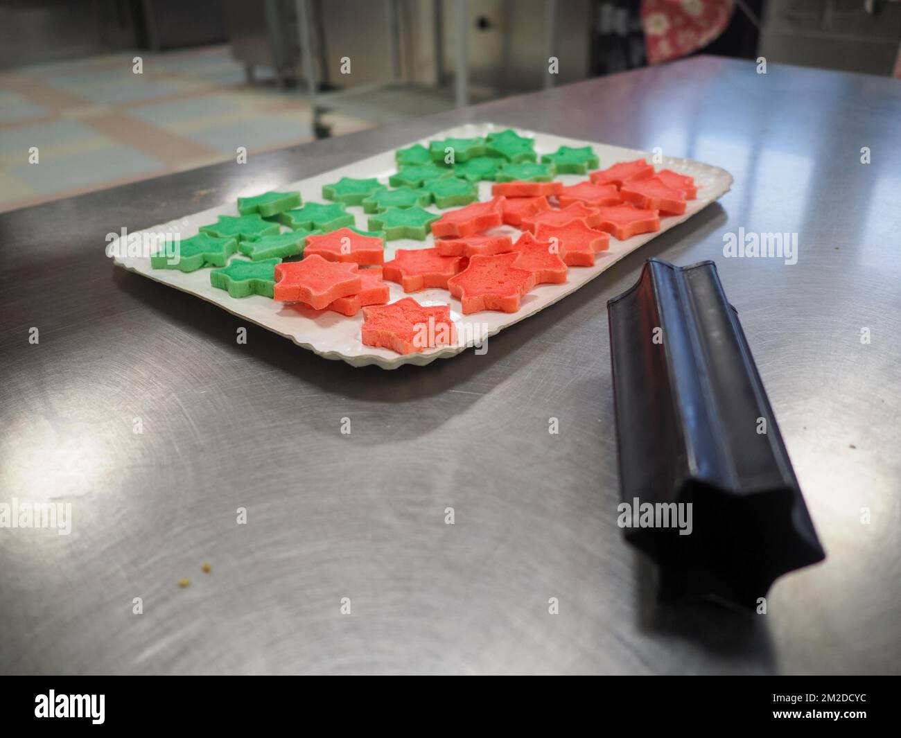 baker chef slicing red violet yellow and green star and heart shaped ...