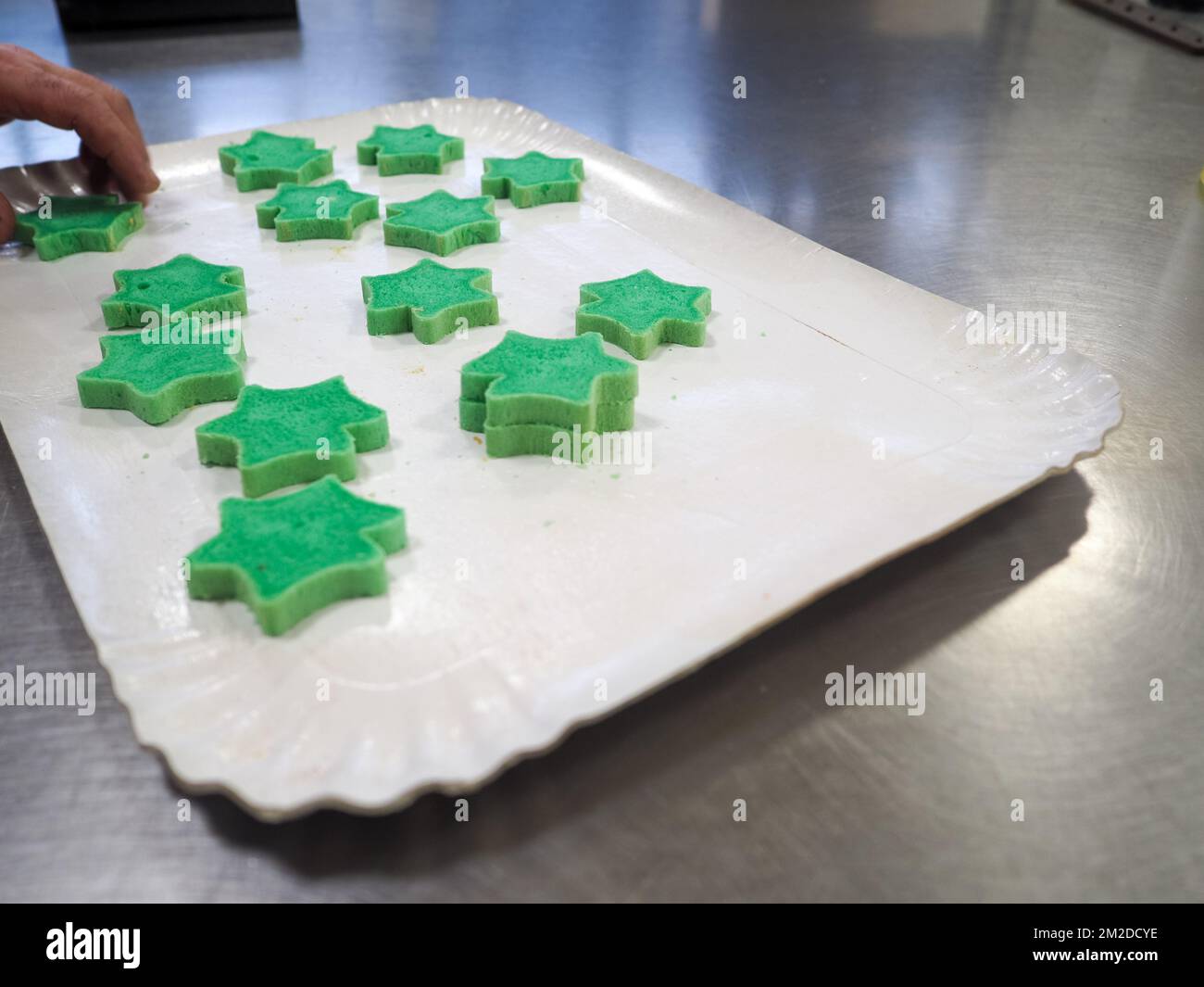 baker chef slicing red violet yellow and green star and heart shaped ...