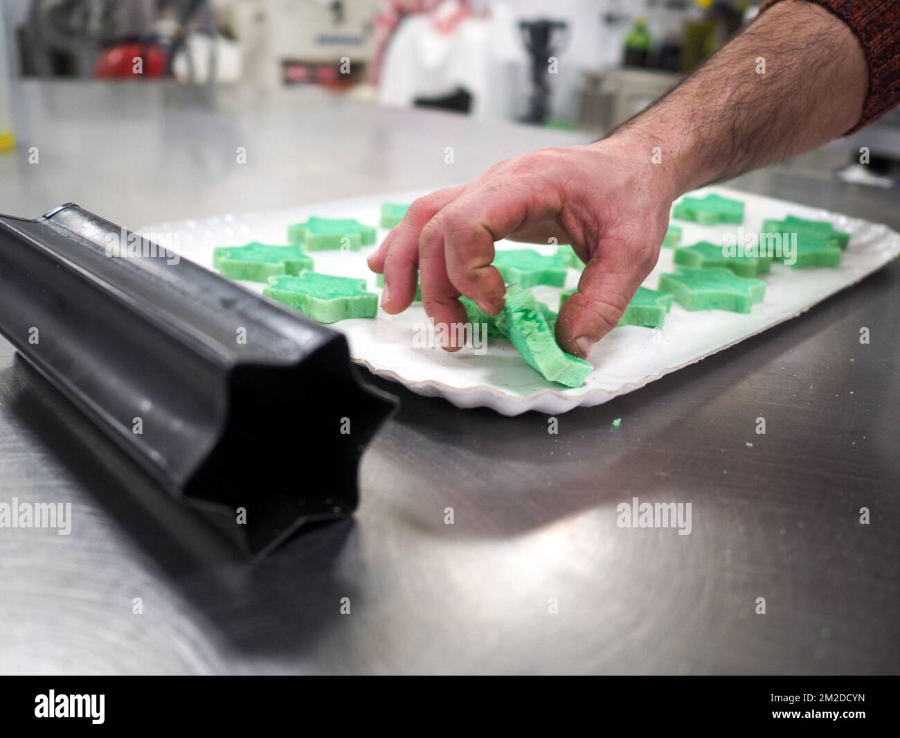 baker chef slicing red violet yellow and green star and heart shaped ...