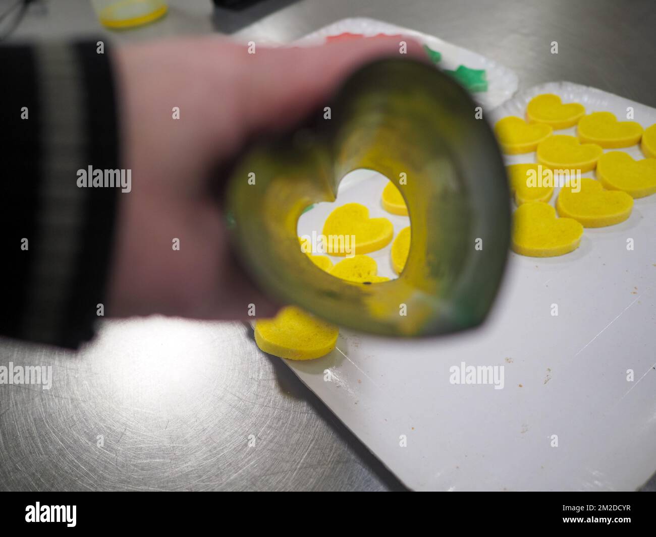 baker chef slicing red violet yellow and green star and heart shaped ...