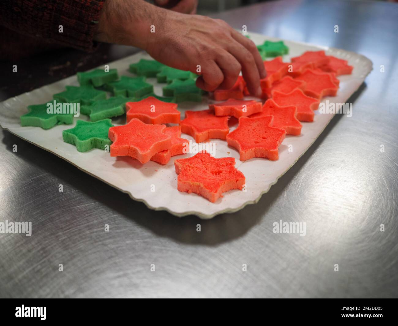 baker chef slicing red violet yellow and green star and heart shaped ...