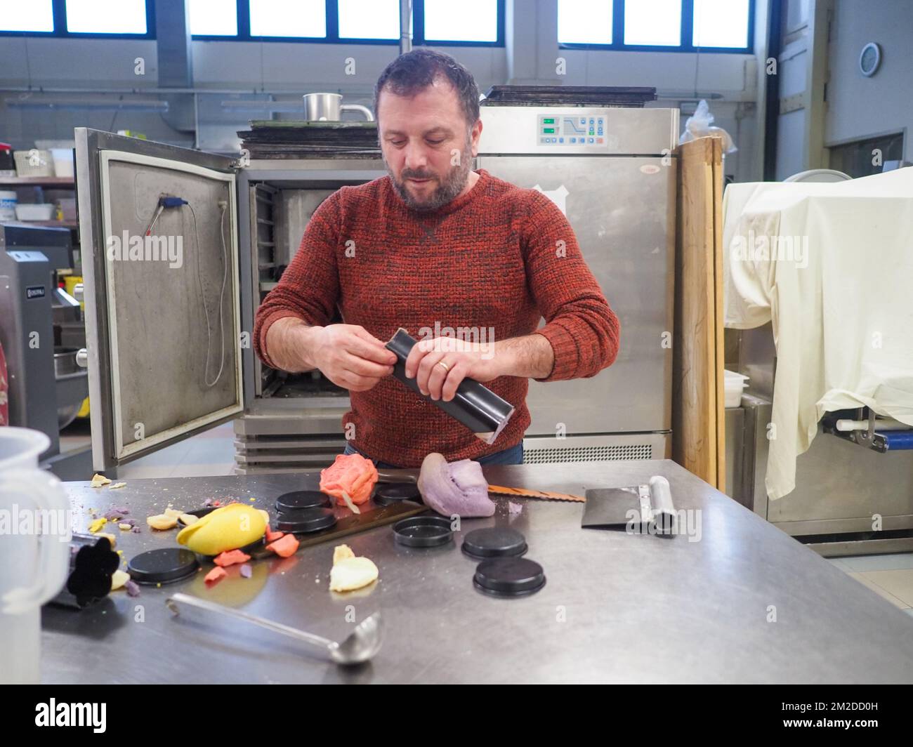 baker chef slicing red violet yellow and green star and heart shaped ...