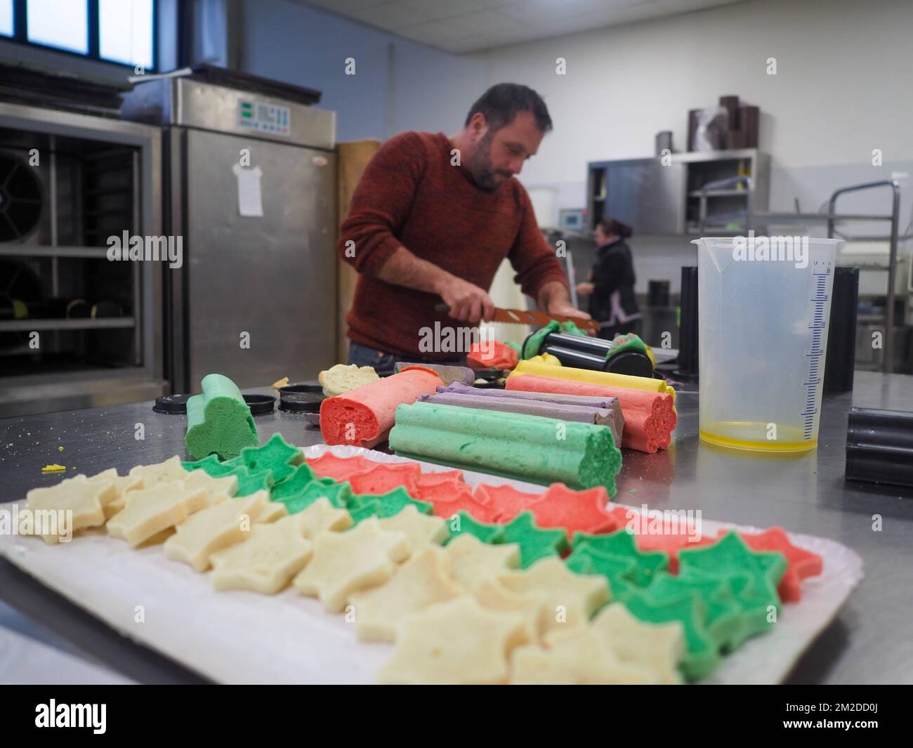 baker chef slicing red violet yellow and green star and heart shaped ...