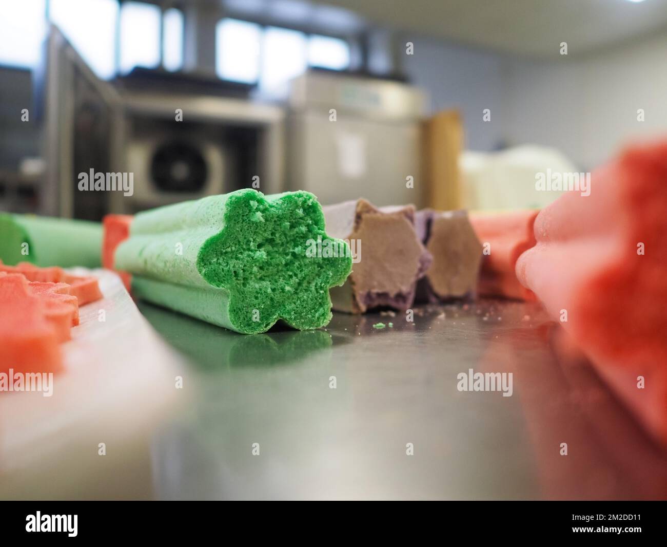 baker chef slicing red violet yellow and green star and heart shaped ...