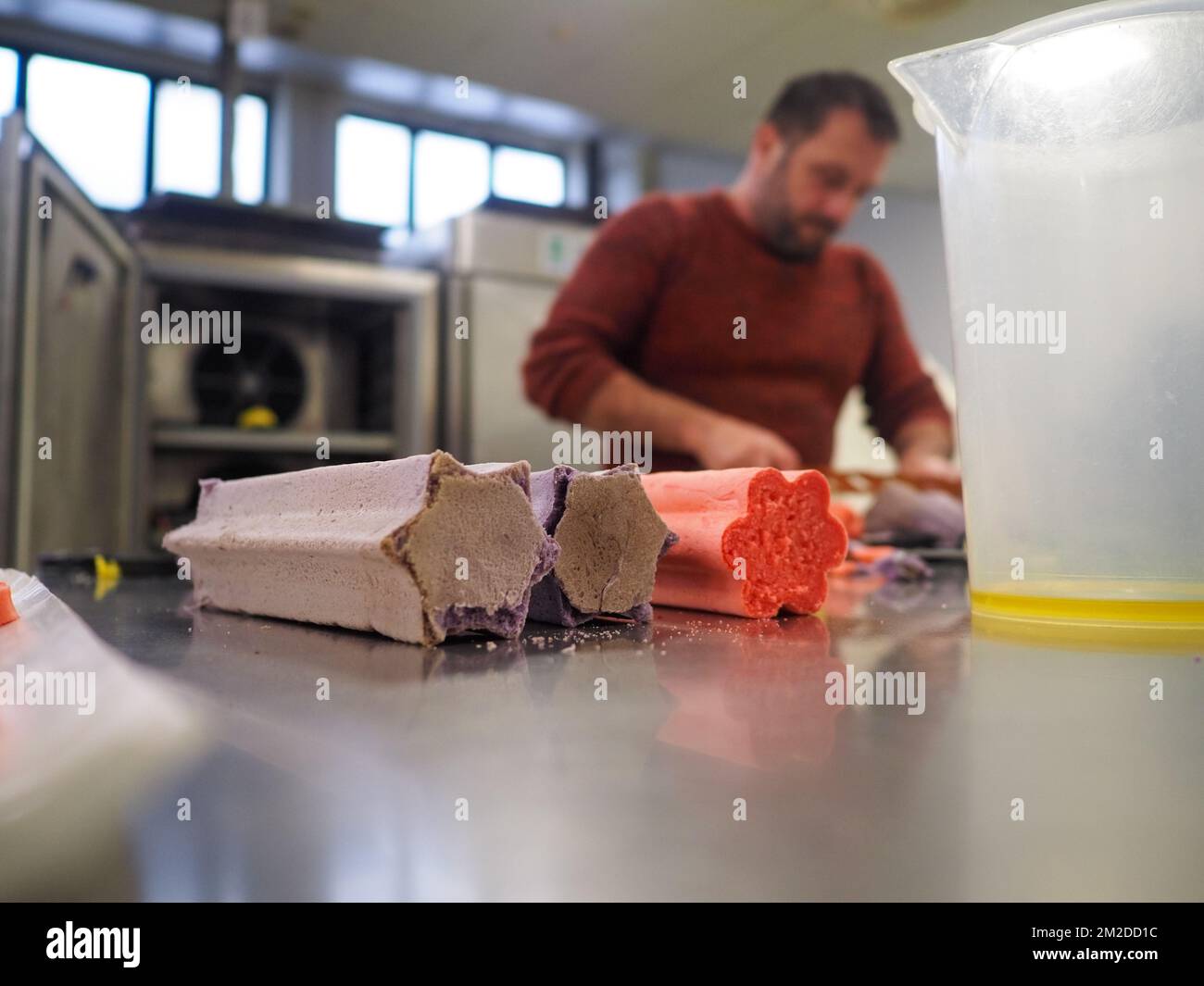 baker chef slicing red violet yellow and green star and heart shaped ...