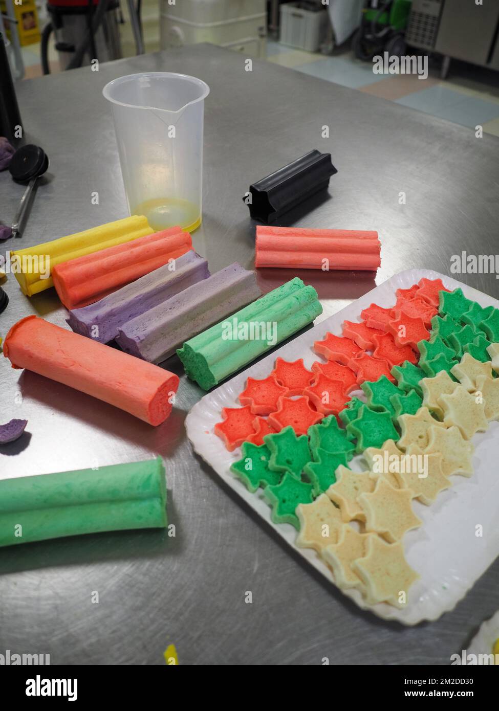 baker chef slicing red violet yellow and green star and heart shaped ...