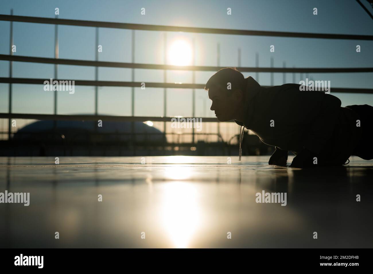 Young caucasian man doing push-ups in the boxing ring outdoors at ...