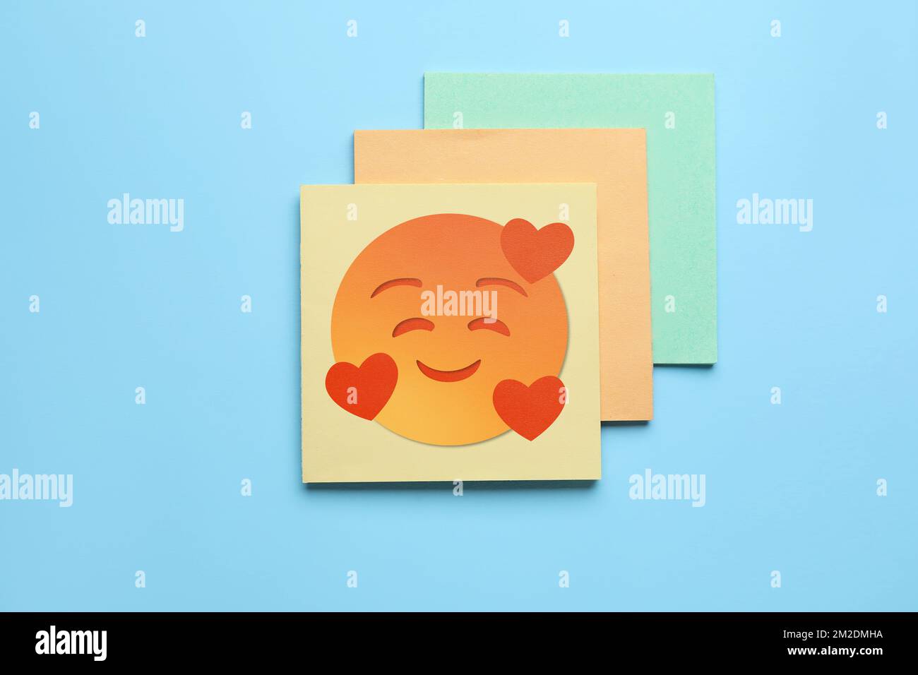 Sticky note with happy emoticon on light blue background Stock Photo ...