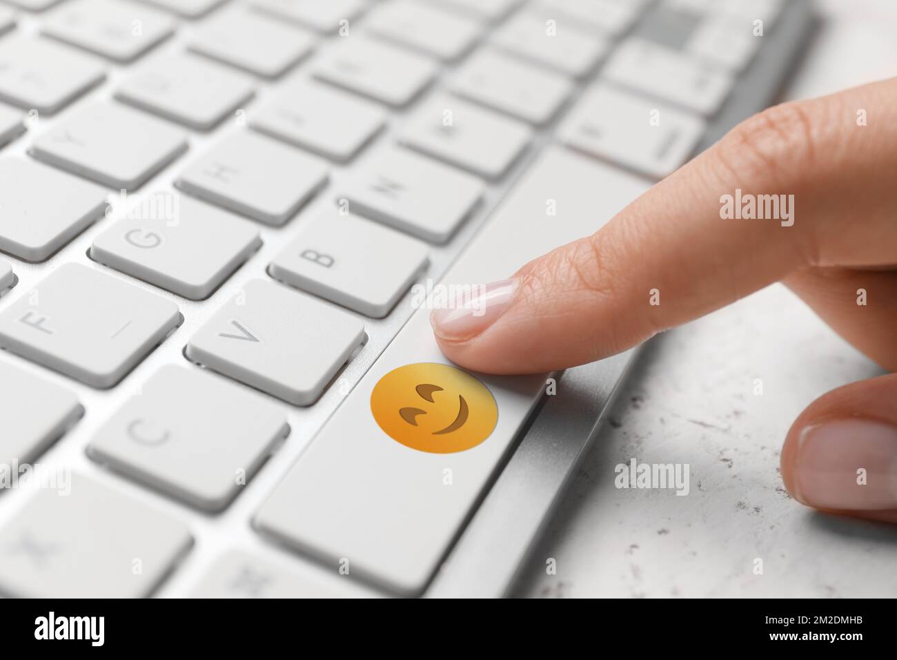 Woman pressing key with happy emoticon on PC keyboard, closeup Stock ...