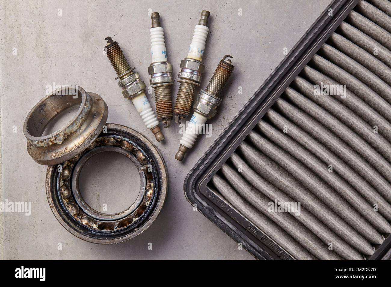 Used bearings, spark plugs and air filters that must be replaced in a ...