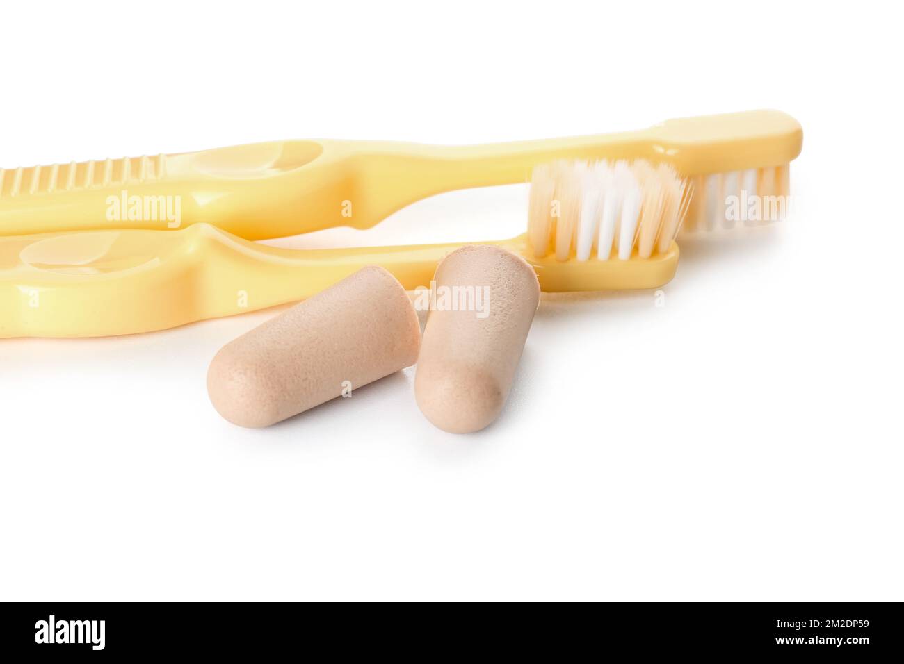 Toothbrushes and ear plugs on white background Stock Photo - Alamy