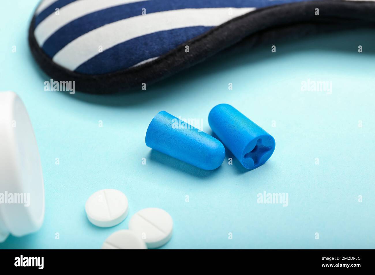 Foam earplugs on blue background Stock Photo - Alamy