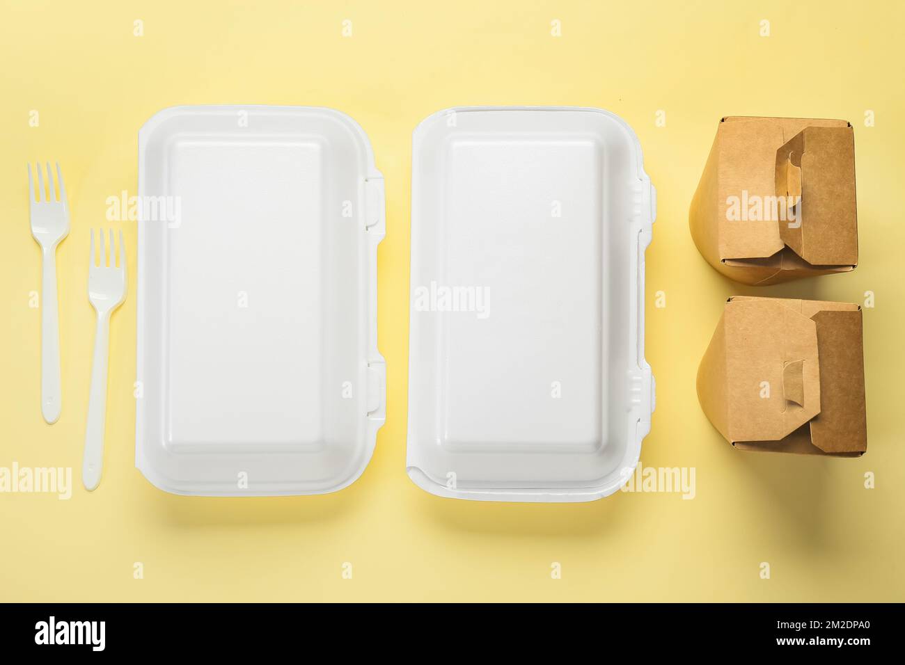 Different food boxes and forks on color background Stock Photo - Alamy