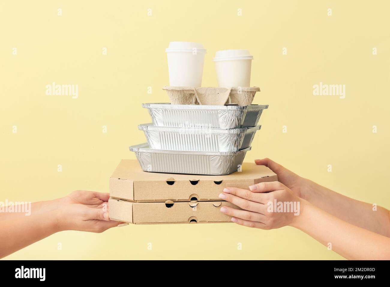 Female hands with stack of different food delivery containers on color ...
