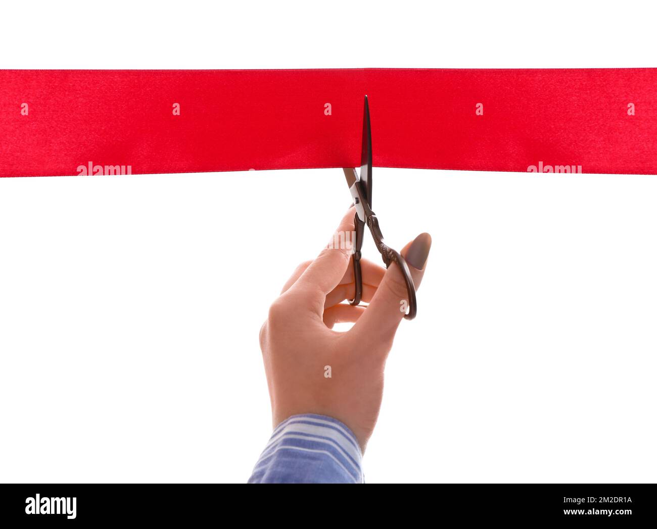 Woman cutting red ribbon with vintage scissors on white background ...