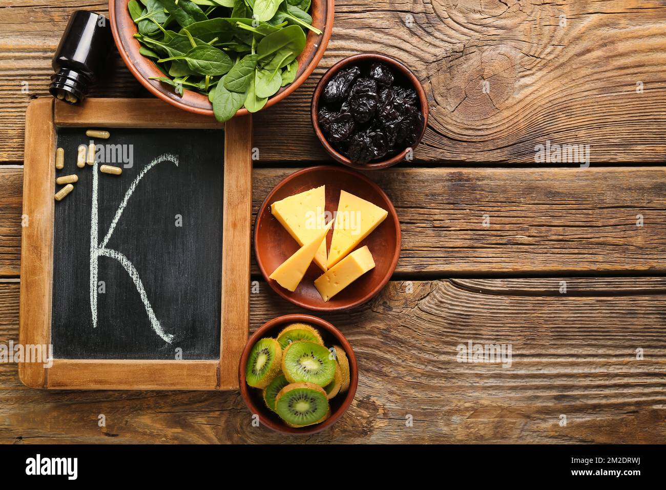 Chalkboard with letter K, bottle of pills and healthy products on ...