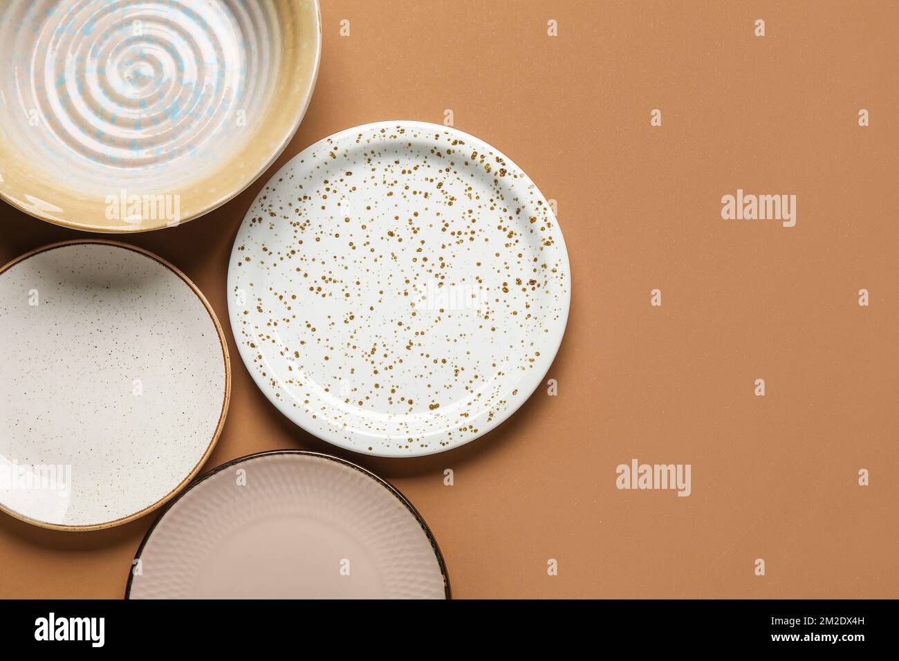 Empty plates on brown background Stock Photo - Alamy