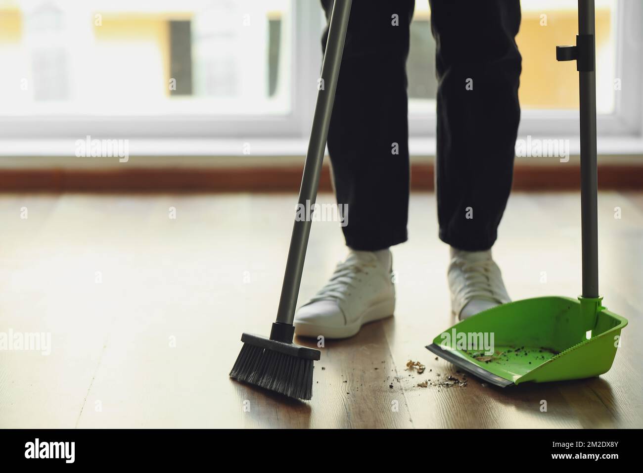 Woman sweeping dust dustpan hi-res stock photography and images - Alamy
