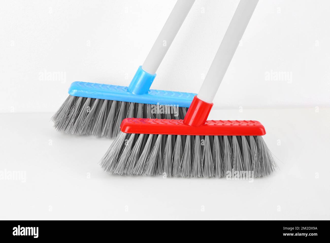 Cleaning brooms isolated on white background, closeup Stock Photo - Alamy
